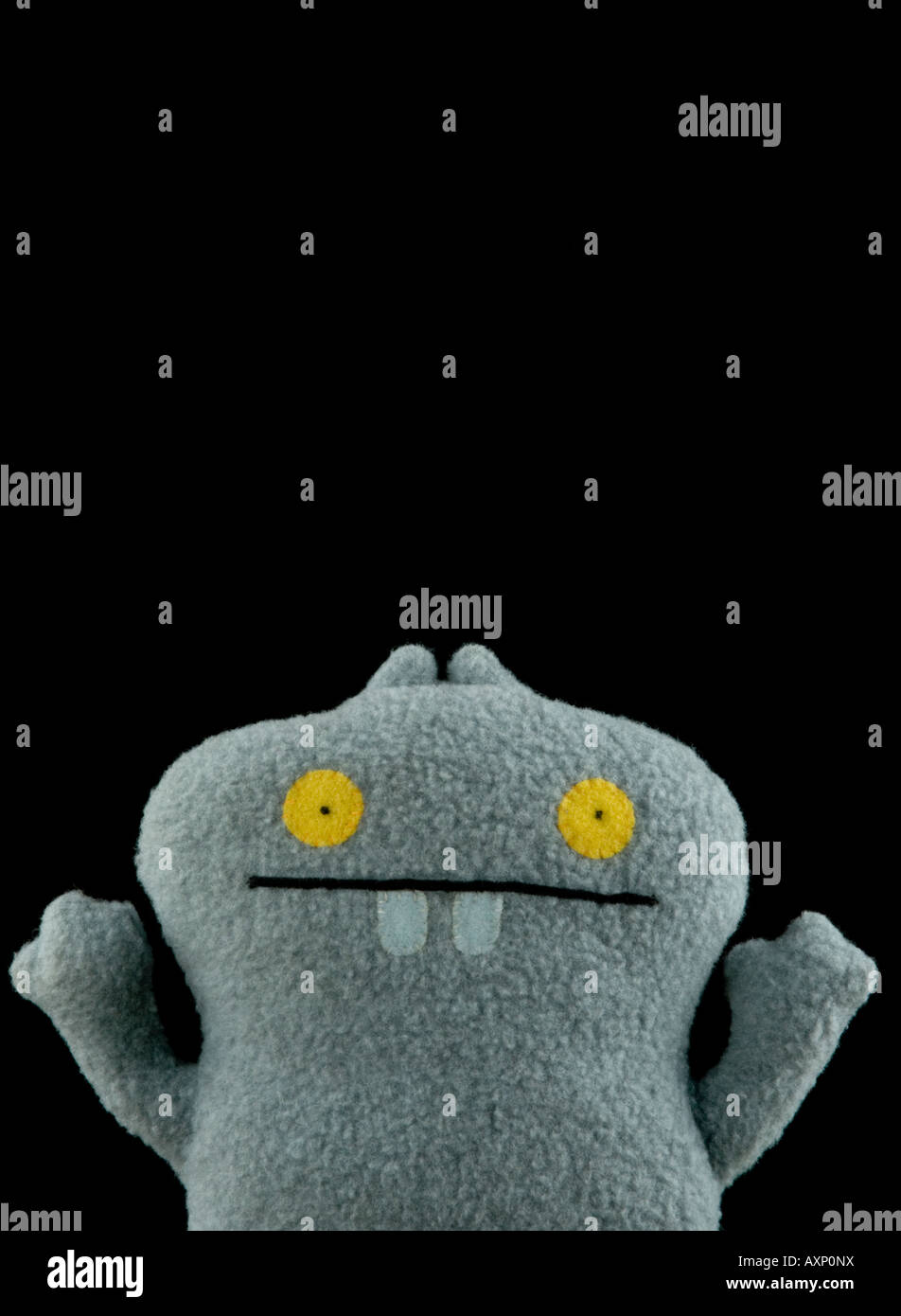 Soft toy scary grey monster back lit with black background Stock Photo ...