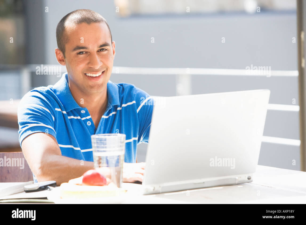 Young man typing on laptop Stock Photo - Alamy