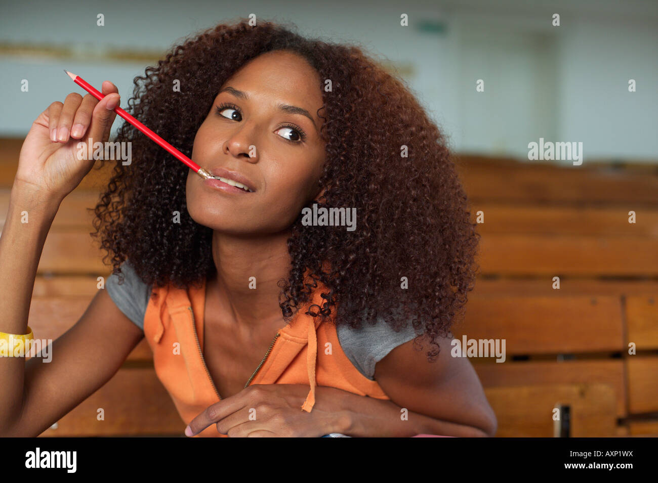 Afro-American woman chewing on a stick in an auditory, selective focus ...