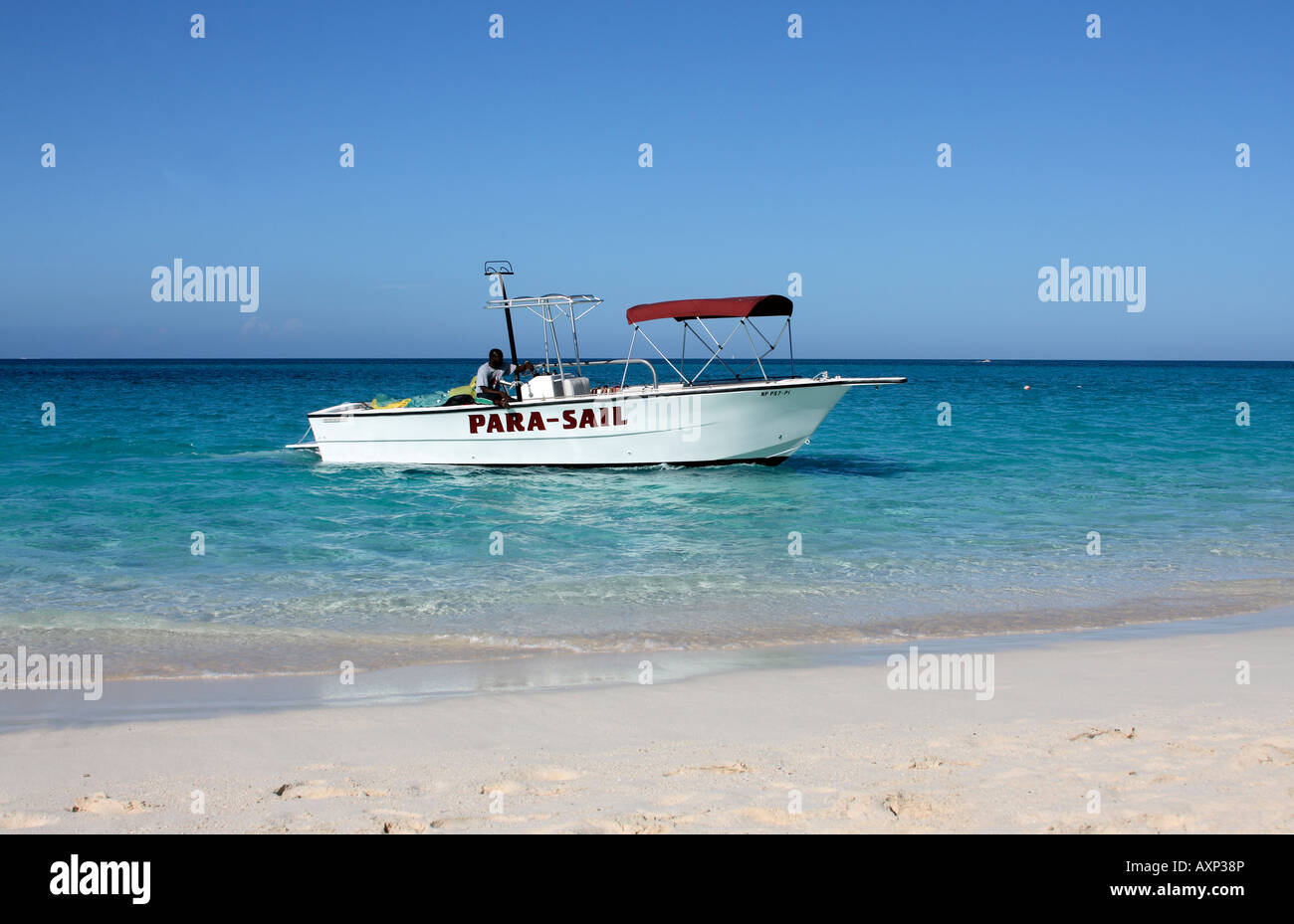 Bahamas beach Paradise island with a white boat with a sailor with blue ...