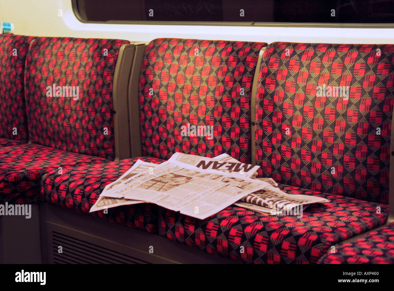 A newspaper left on a seat in a London Underground train Stock Photo ...