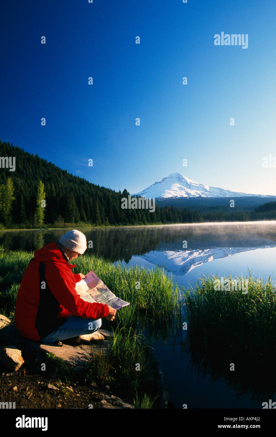 Reading a map by mountain lake Stock Photo - Alamy