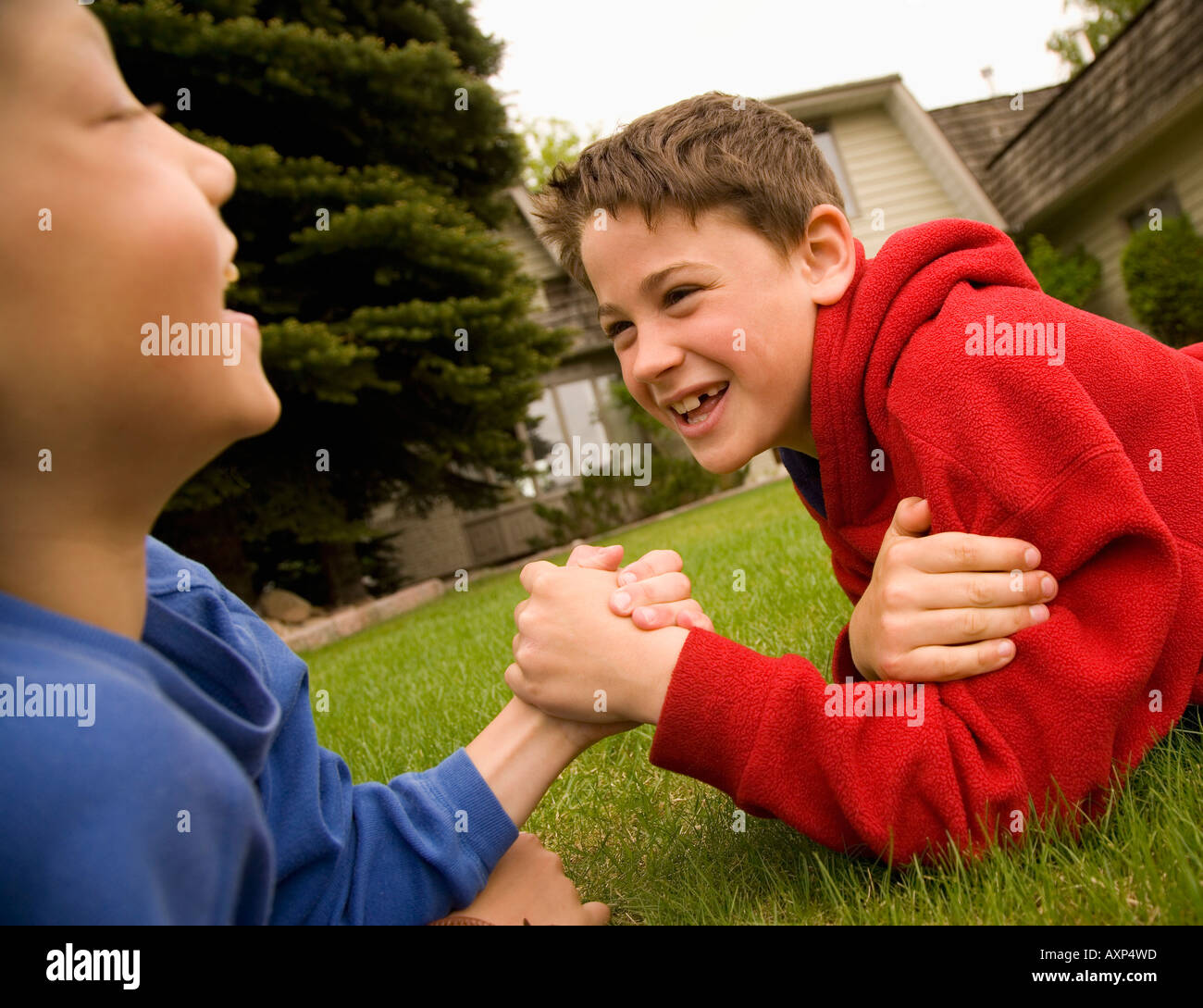 Boys arm wrestling Stock Photo - Alamy