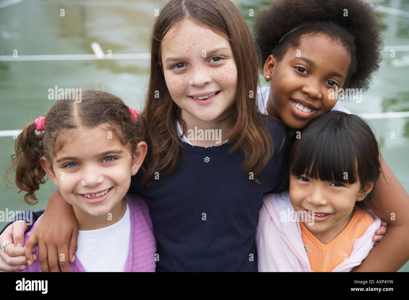 Multi-ethnic children hugging Stock Photo - Alamy