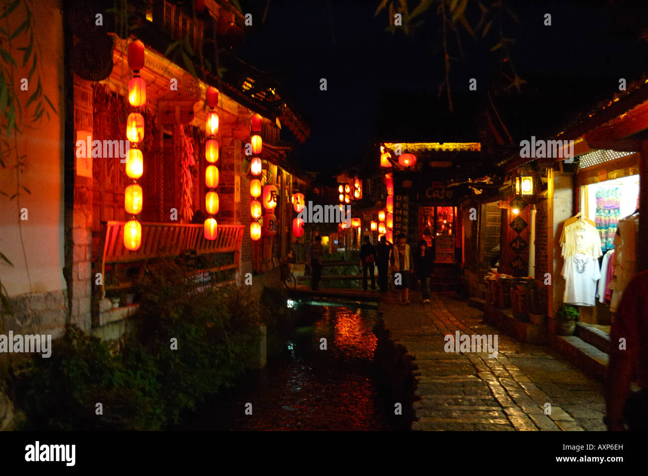 Lijiang at night. Red lanterns decorate the shops along the street and ...