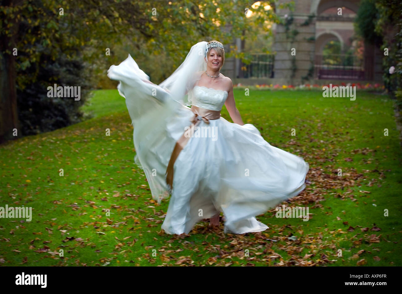 Bride running on lawn Stock Photo - Alamy