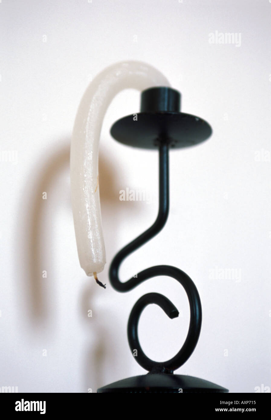 Burnt out exhausted and bent crooked candle Stock Photo - Alamy