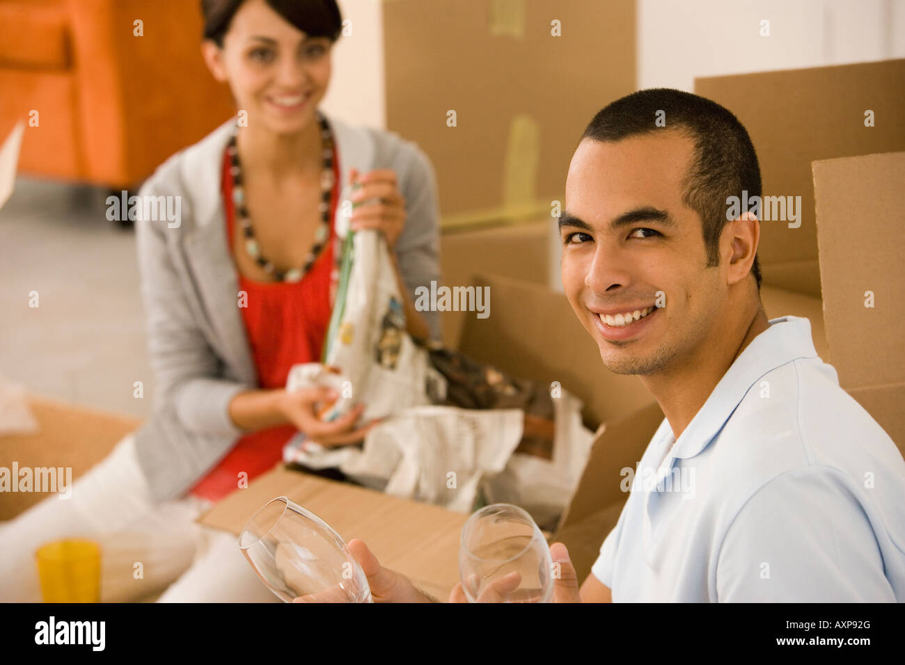 Young couple packing moving boxes Stock Photo - Alamy