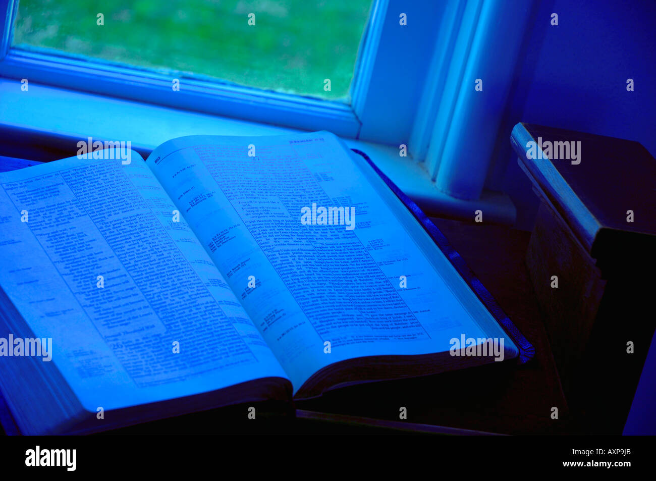 Open Bible at window side Stock Photo - Alamy