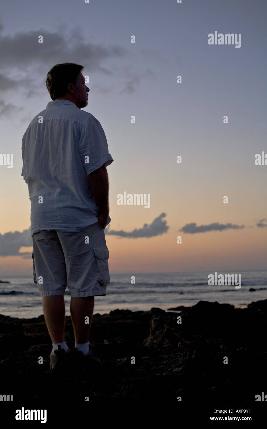 Tourist man looking out over the ocean Stock Photo - Alamy