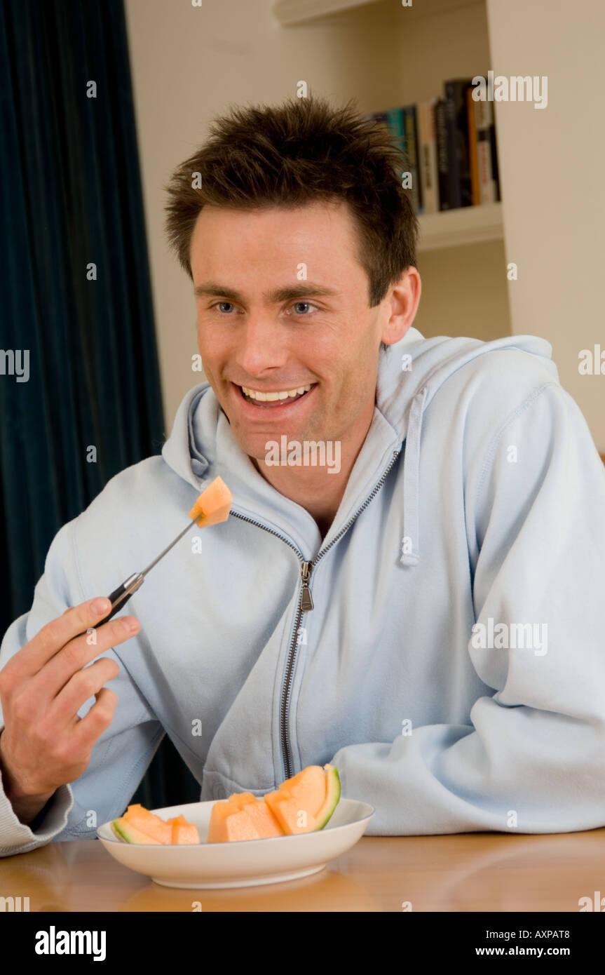 man eating melon slices Stock Photo - Alamy
