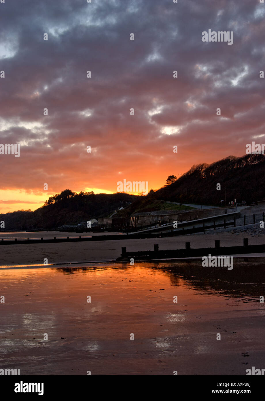 Sunset reflections on the beach Stock Photo - Alamy