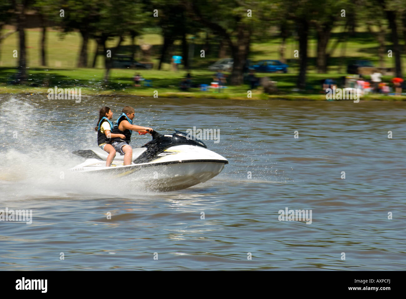 Teenage boy and girl on jet ski Stock Photo - Alamy