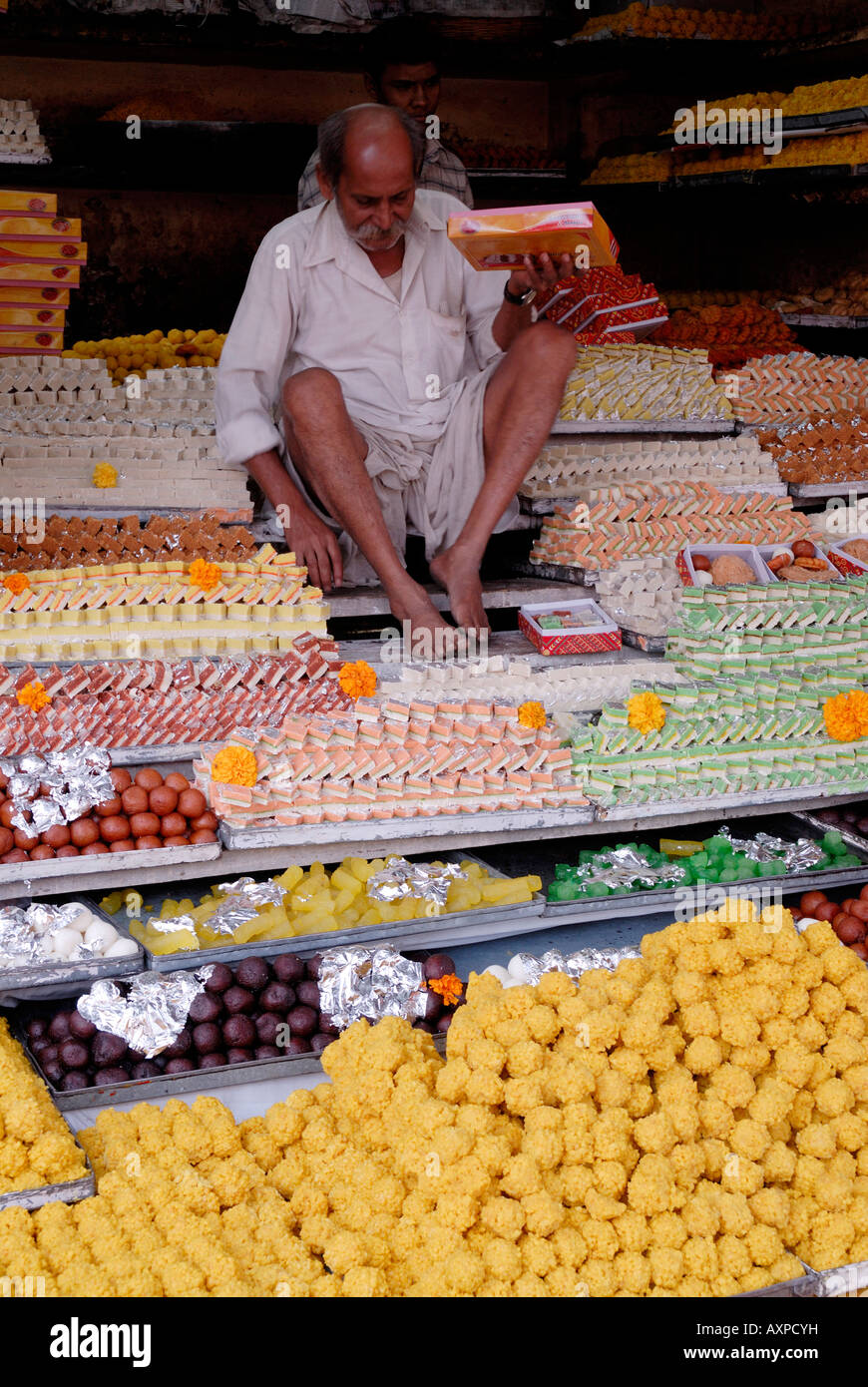 Man selling sweets in his shop in a street in Jaipur Rajasthan India ...