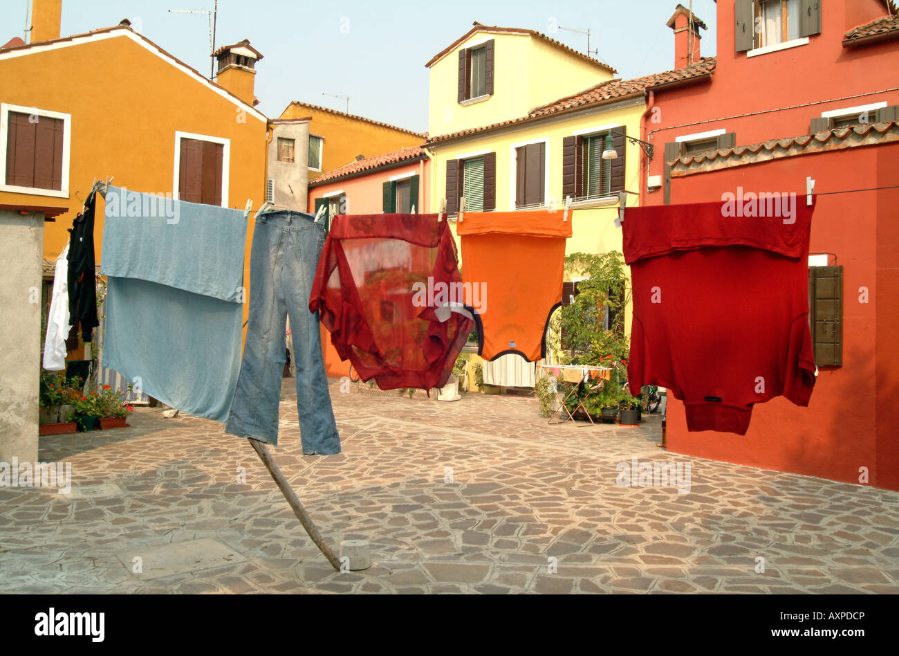 Washing line in a cobbled square with the brightly painted houses of ...