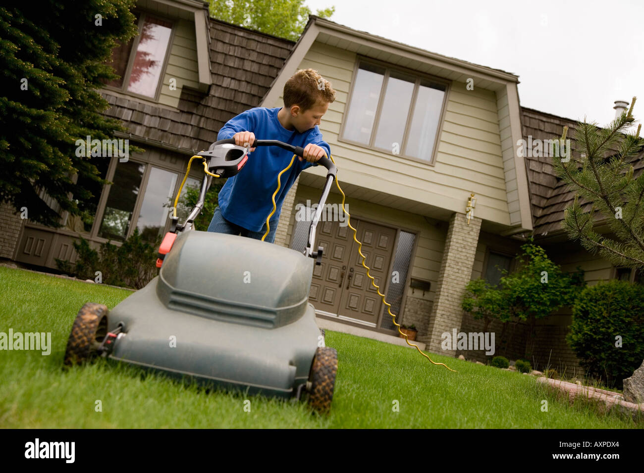 Boy Pushing Lawnmower Stock Photo - Alamy