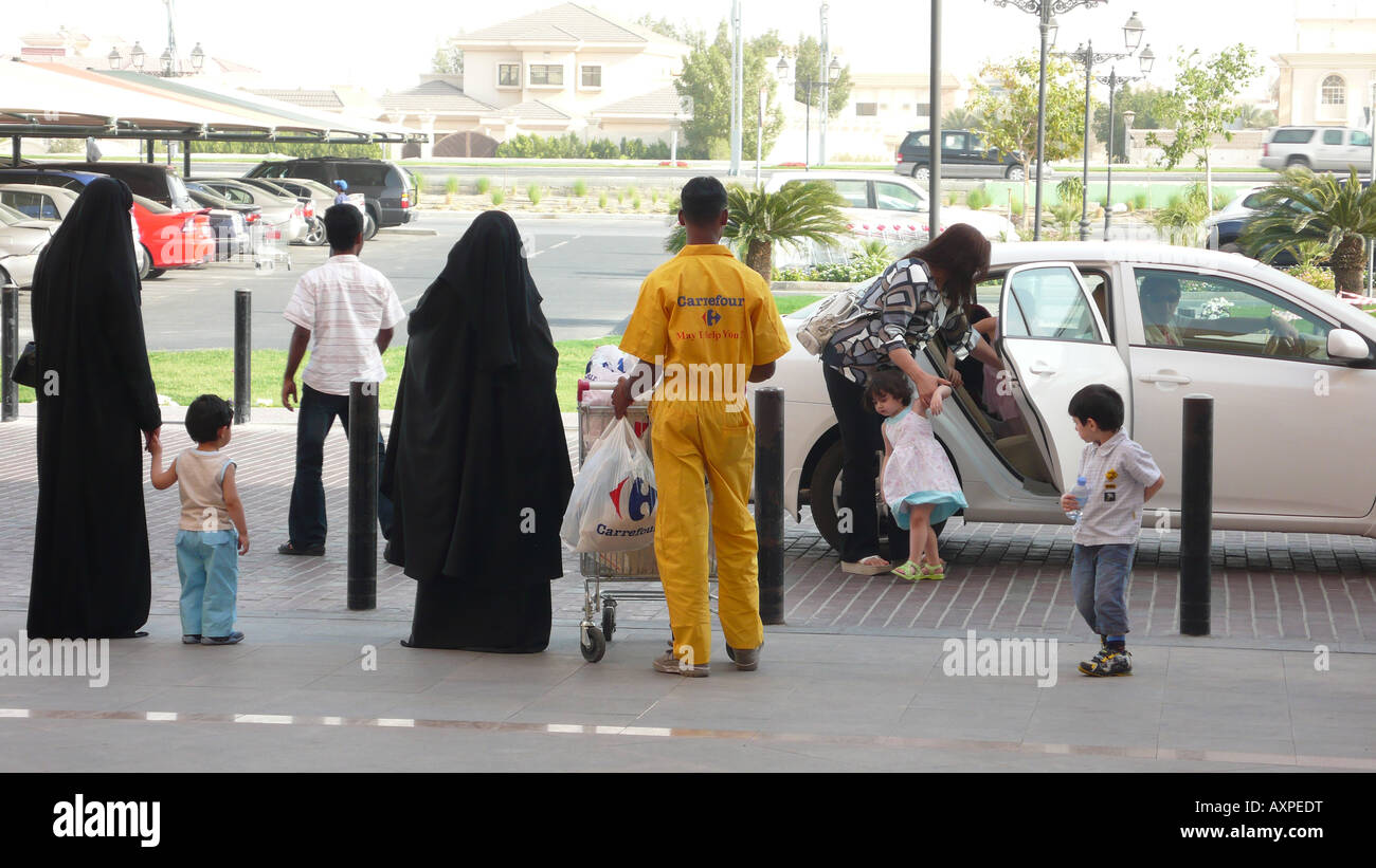 Shoppers and a Carrefour staff member outside the Villaggio Mall in the ...