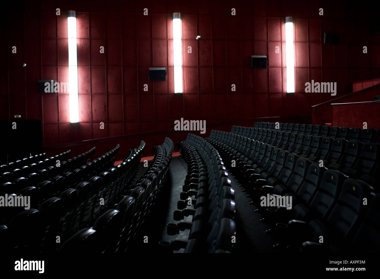 row of seats in a public hall with lights on Stock Photo - Alamy
