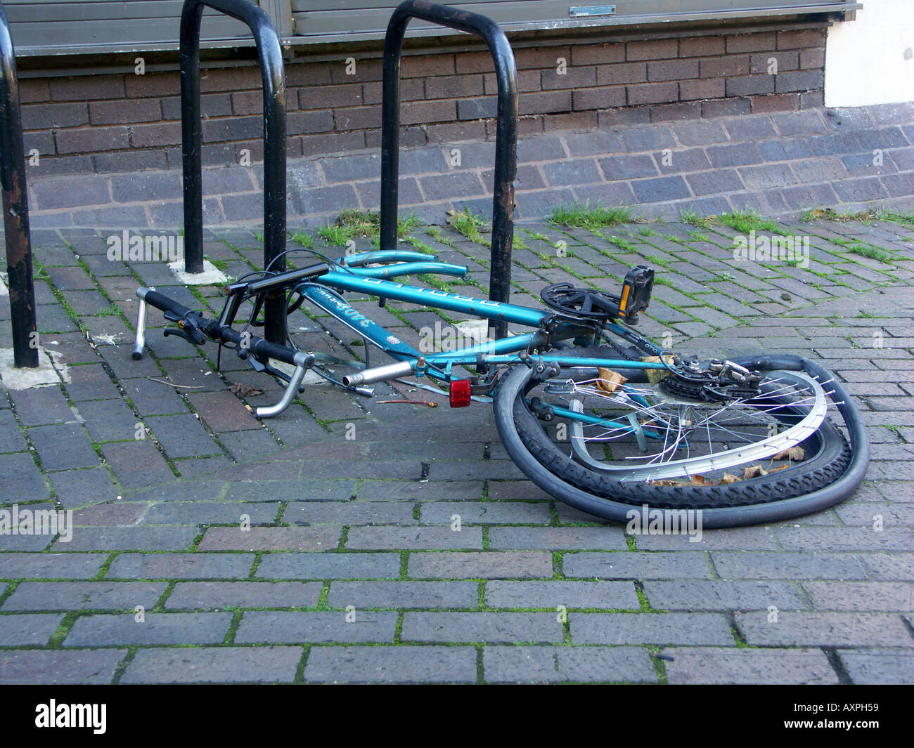 Stripped cycle still locked to bike stand Stock Photo - Alamy
