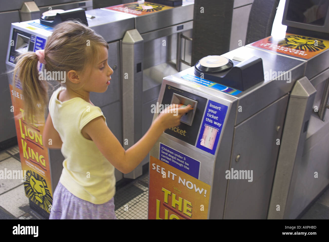 child putting tube ticket into ticket gate machine Stock Photo - Alamy