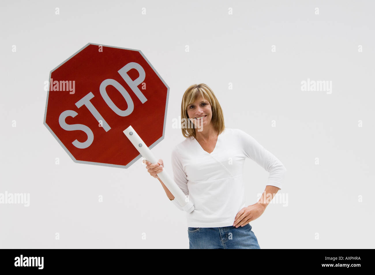 Woman holding stop sign Stock Photo - Alamy
