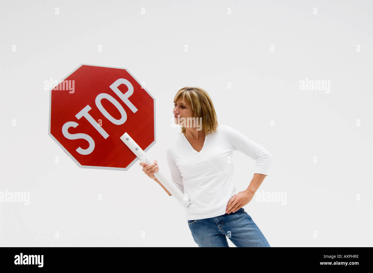 Woman holding stop sign Stock Photo - Alamy