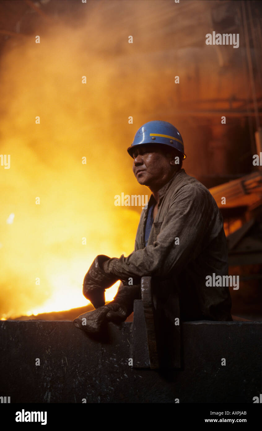 A steel worker in front of a blast furnace in Benxi Iron and Steel ...