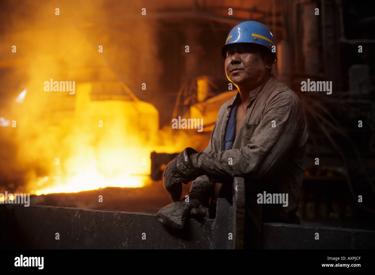 A steel worker in front of a blast furnace in Benxi Iron and Steel ...