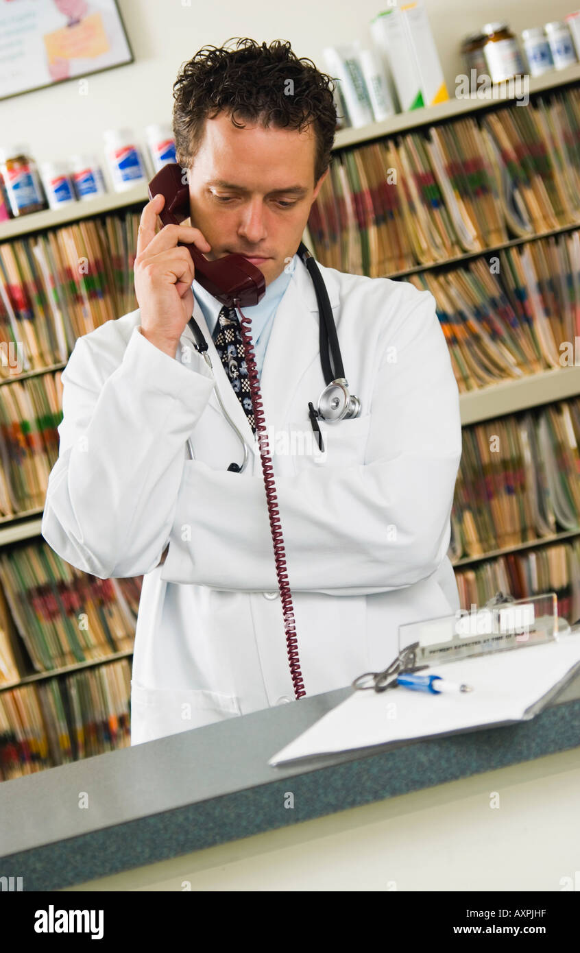 Doctor on telephone Stock Photo - Alamy