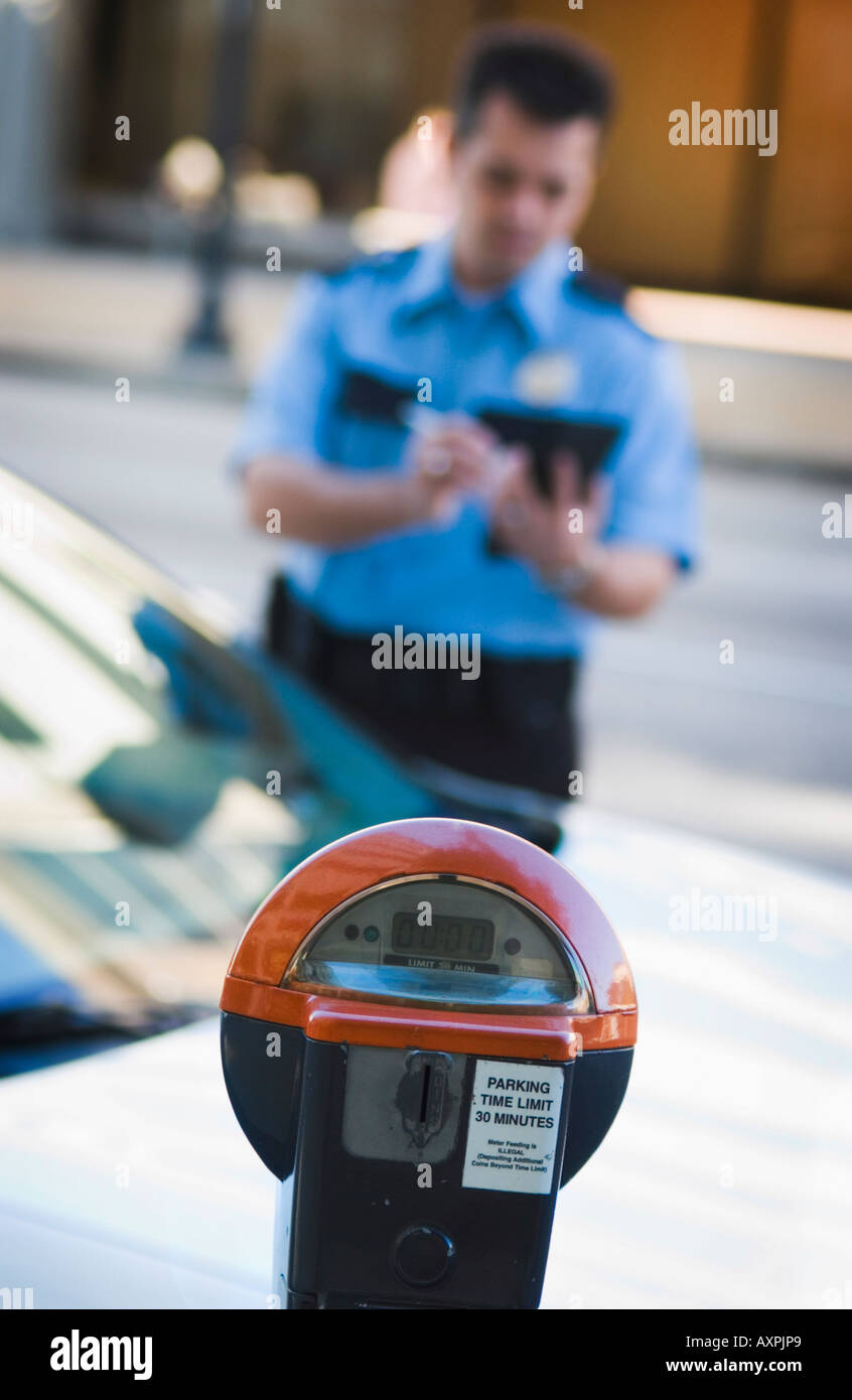 Policeman writing parking ticket Stock Photo - Alamy