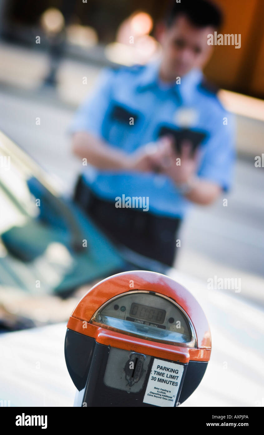 Policeman writing parking ticket Stock Photo - Alamy