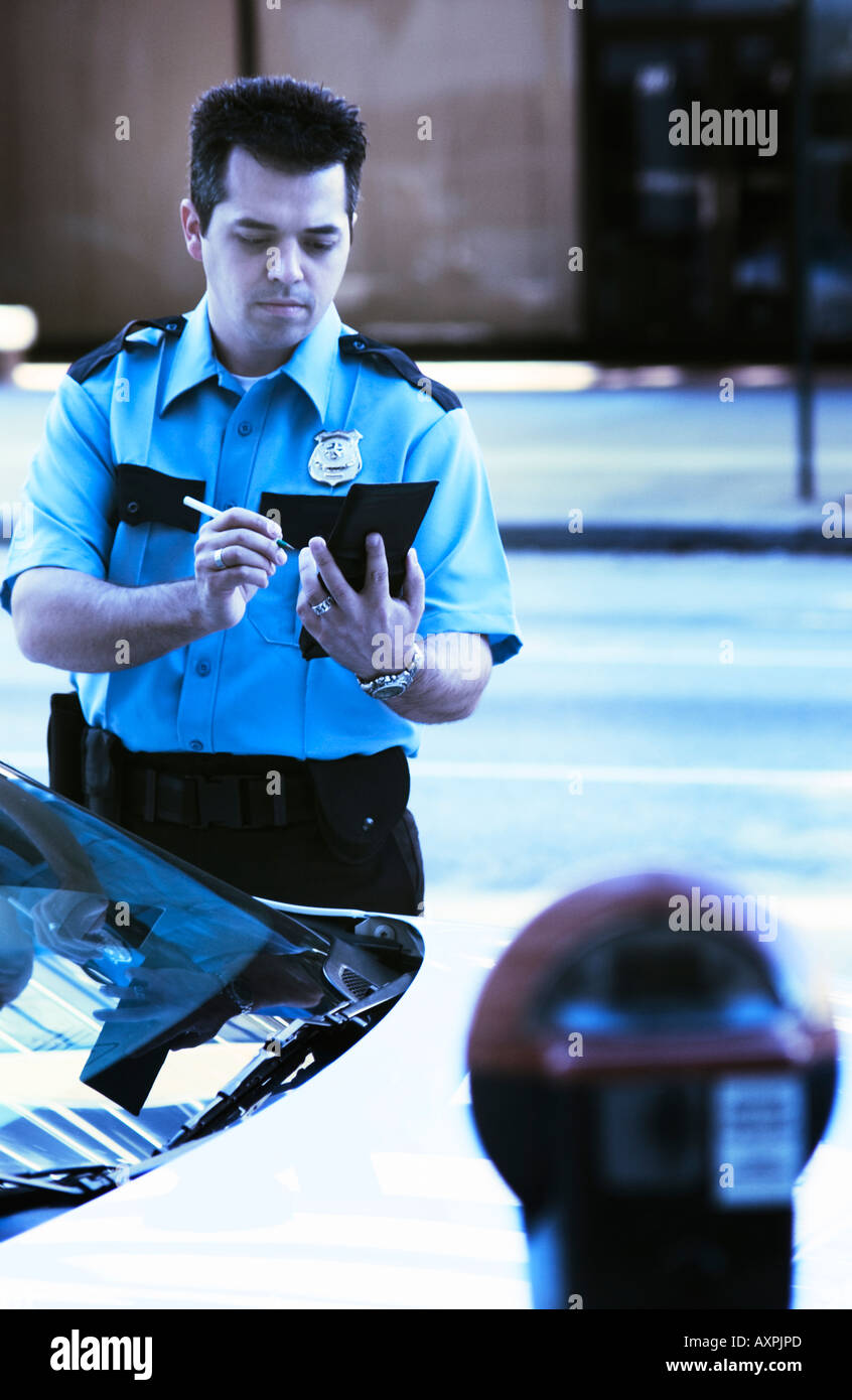 Policeman writing parking ticket Stock Photo - Alamy