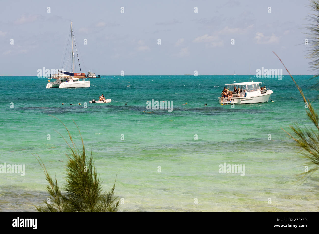 boats anchored and people snorkeling and swimming on Mermaid reef in ...