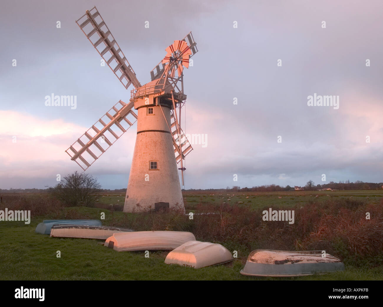 THURNE MILL WITH UPTURNED BOATS AT SUNSET, NORFOLK BROADS, EAST ANGLIA ...