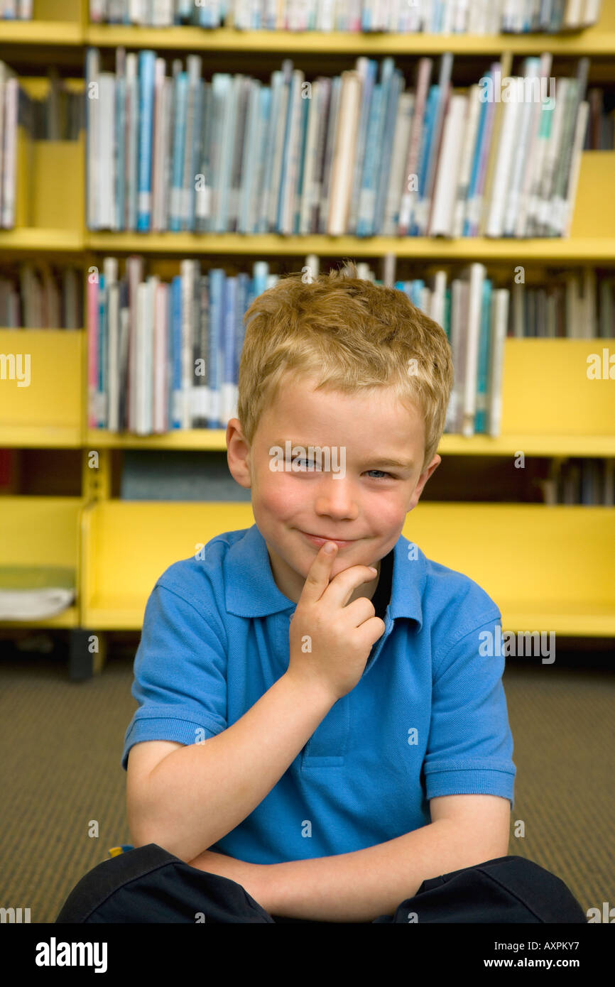 Young boy in library Stock Photo - Alamy