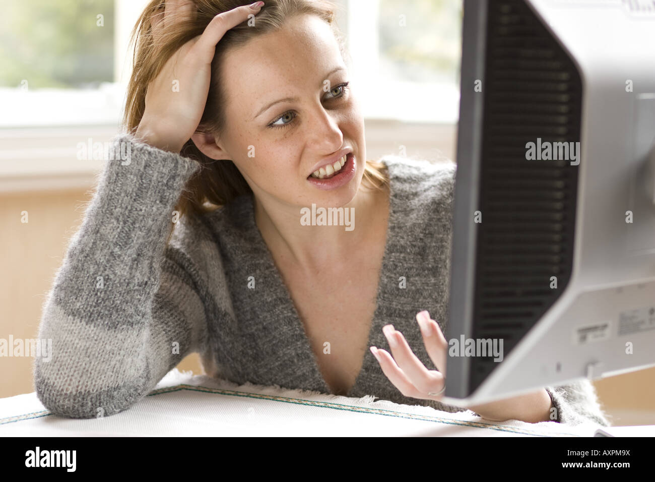 Frustrated woman using computer Stock Photo - Alamy