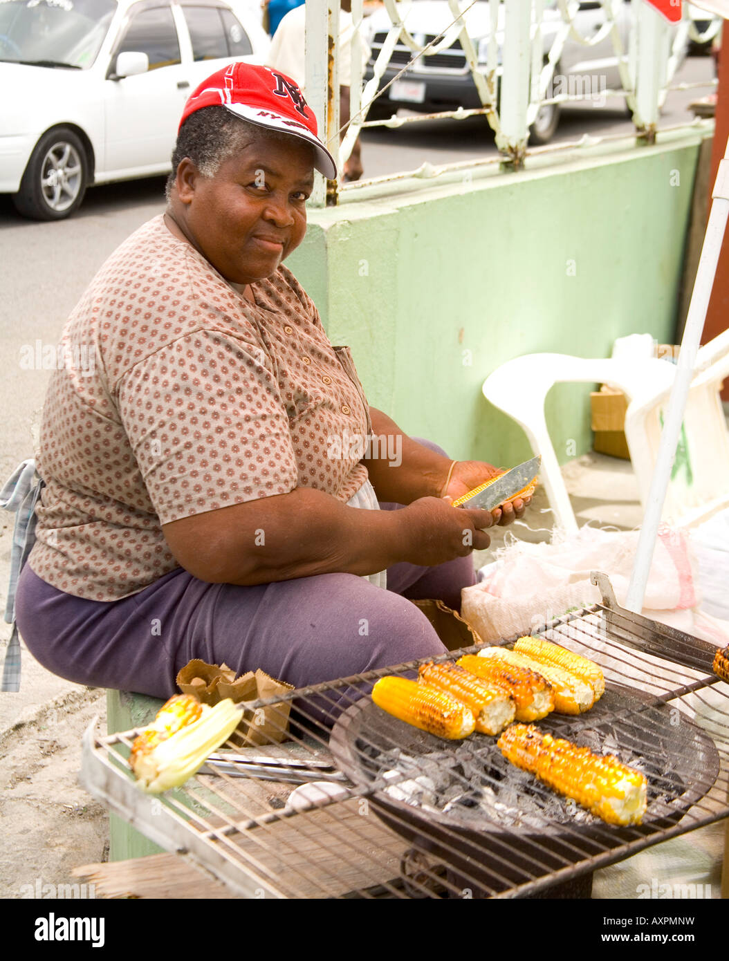 Lady selling grilled corn at Antigua Caribbean Stock Photo - Alamy