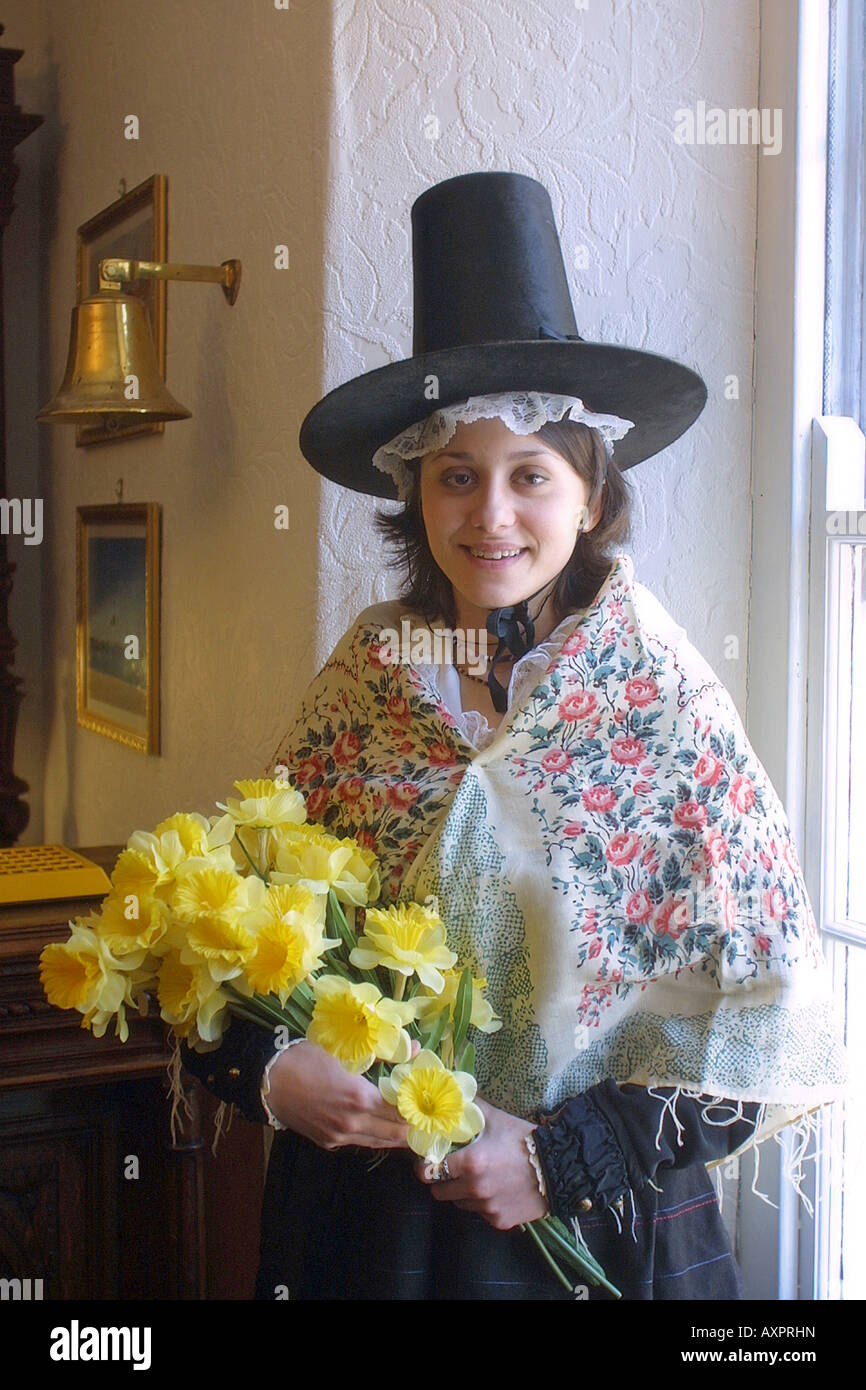 Beautiful girl in welsh costume with yellow daffodils and hat and shawl ...