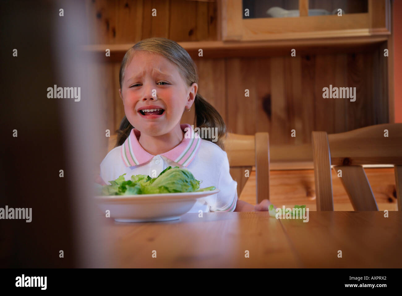Girl crying over dinner Stock Photo - Alamy