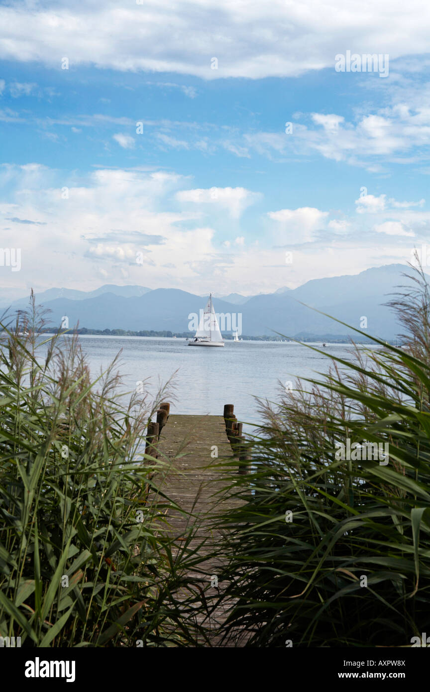 Sailing yacht on Lake Chiem (Chiemsee) with the Bavarian alps in the ...
