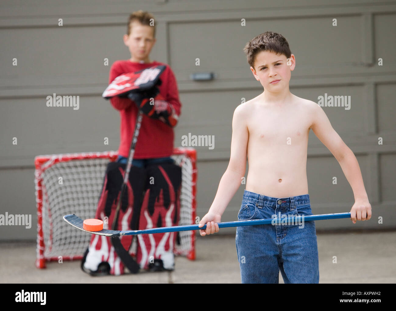 A boy rests a puck on his hockey stick Stock Photo - Alamy
