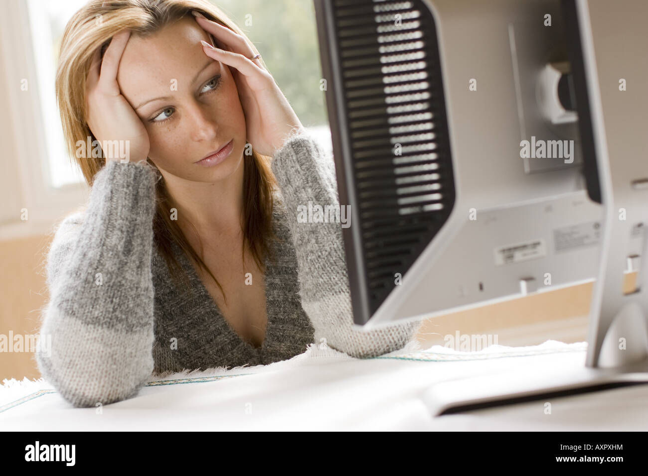 Frustrated woman using computer Stock Photo - Alamy
