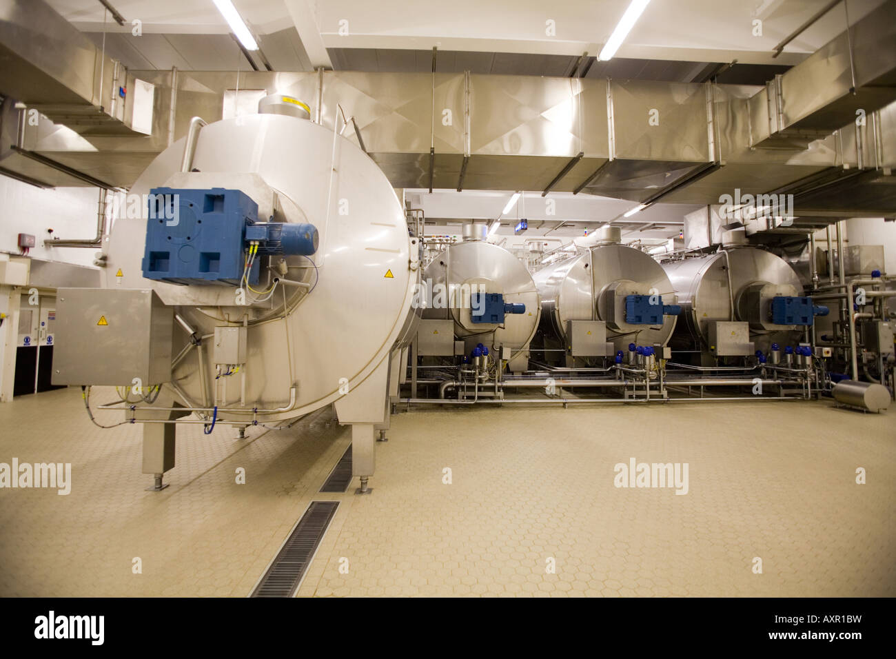 Cheese making drums. Cheese factory processing plant. drums and pipes ...