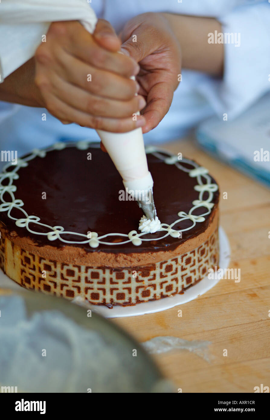 Pastry chef decorating Chocolate Cake Stock Photo - Alamy