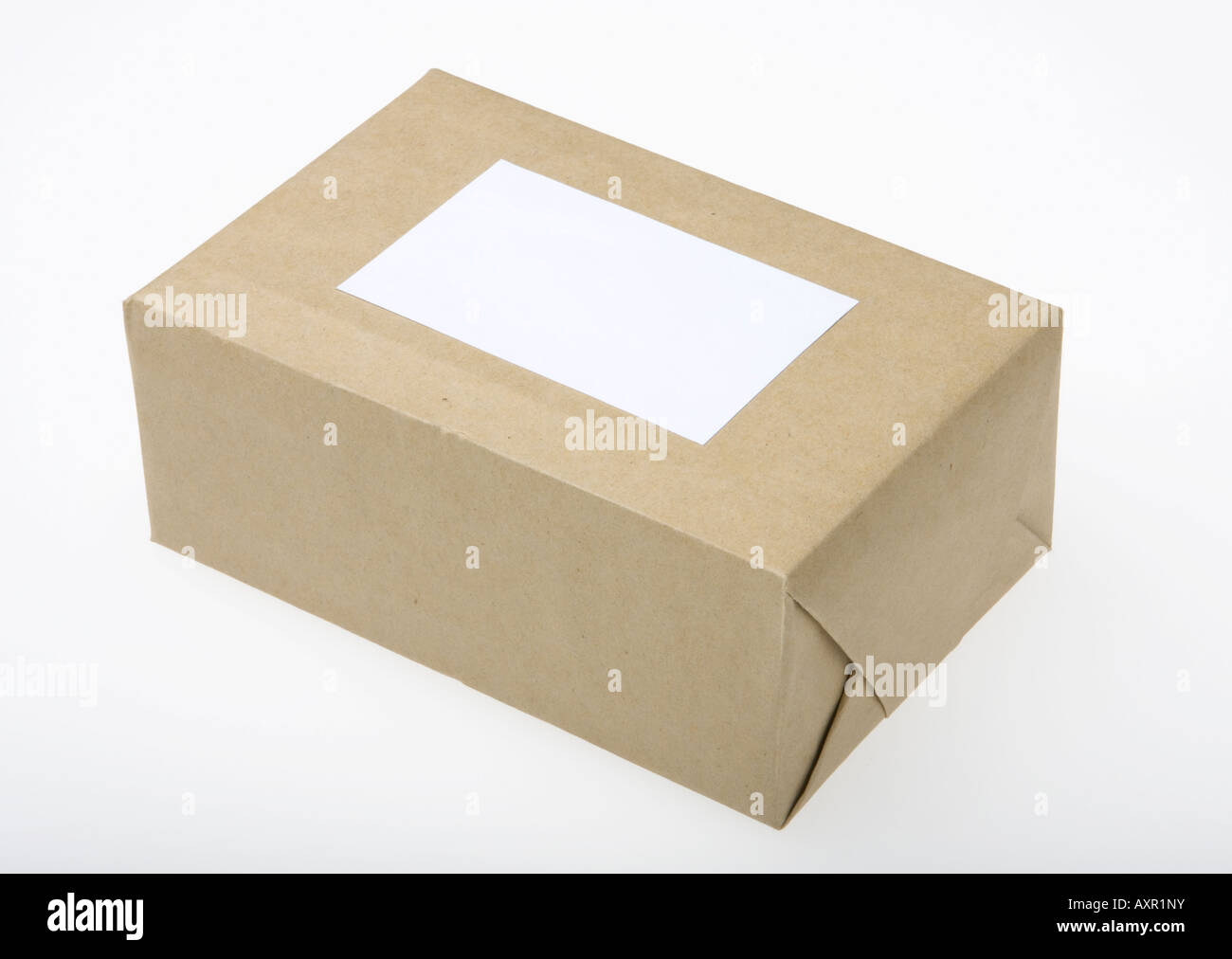 Parcel wrapped in plain brown paper with blank white label Stock Photo ...