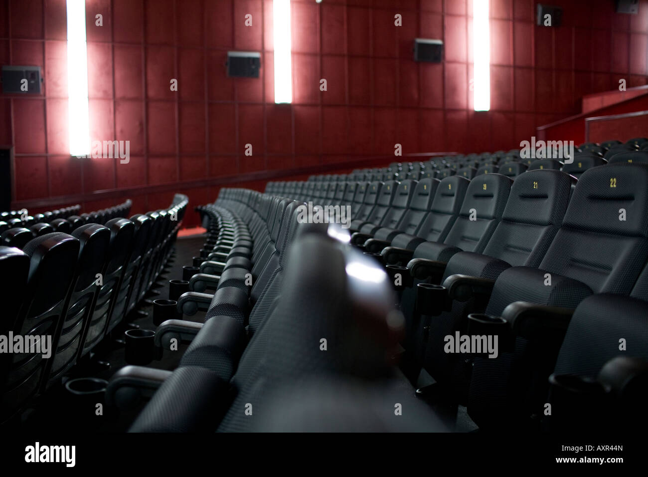 row of seats in a public hall with lights on Stock Photo - Alamy
