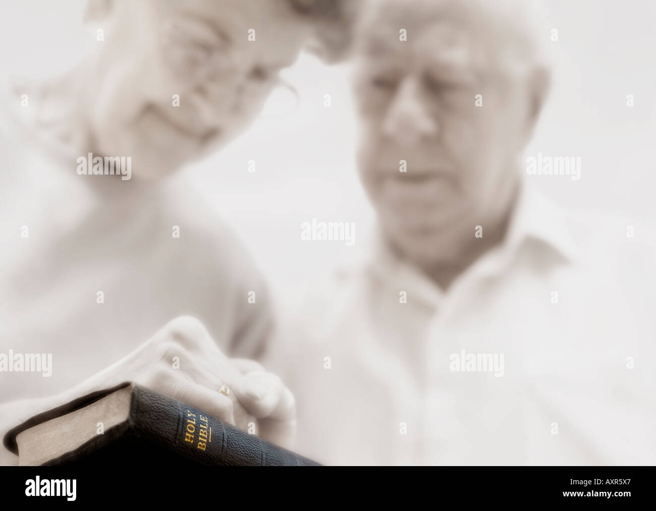 Senior couple praying Stock Photo - Alamy