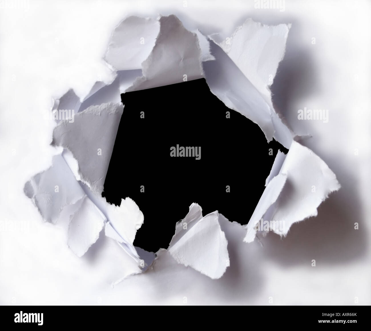Large hole in the white paper with black center (background Stock Photo ...
