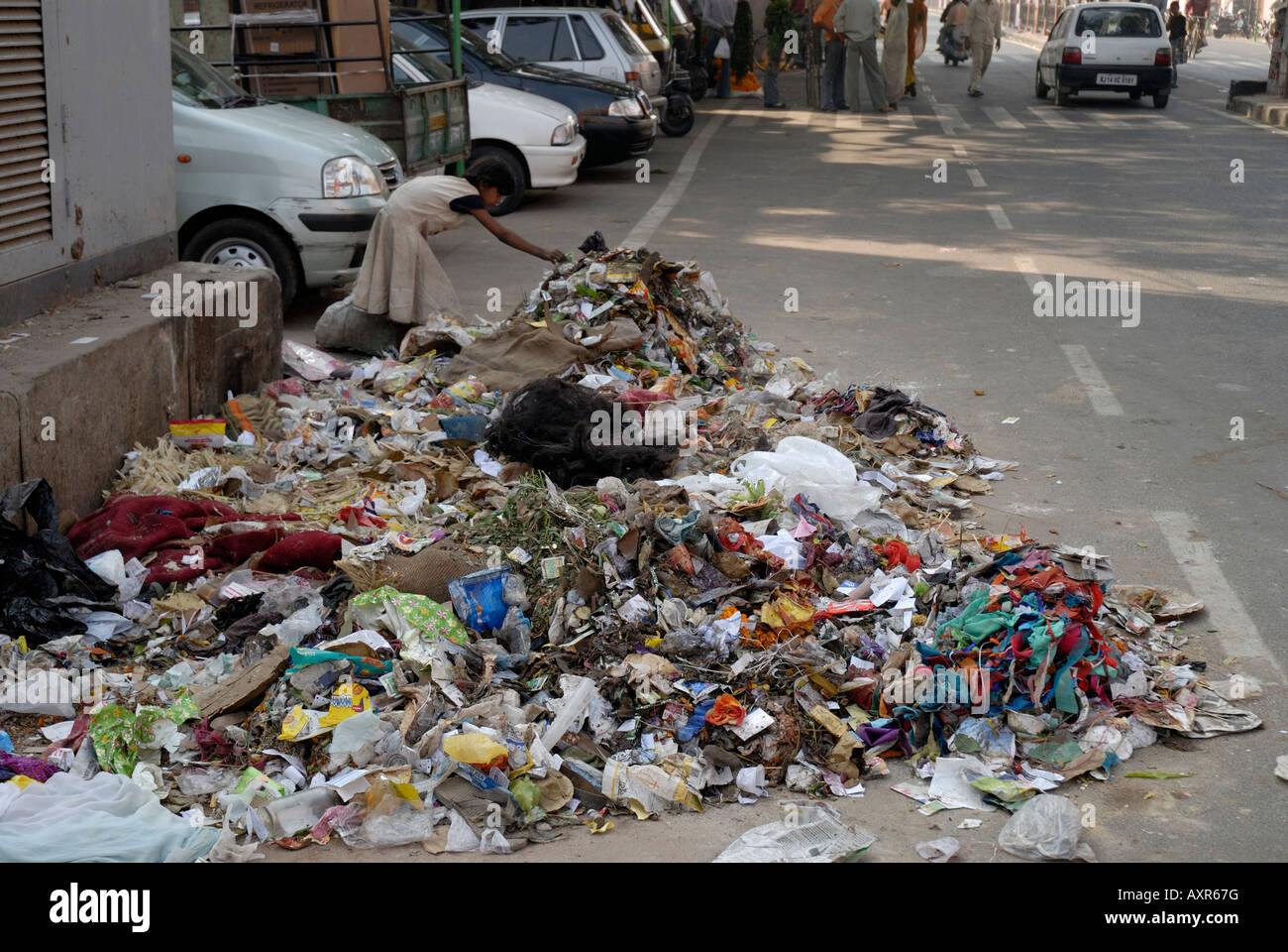 Young girl scavenging amongst street refuse in a street in Jaipur ...