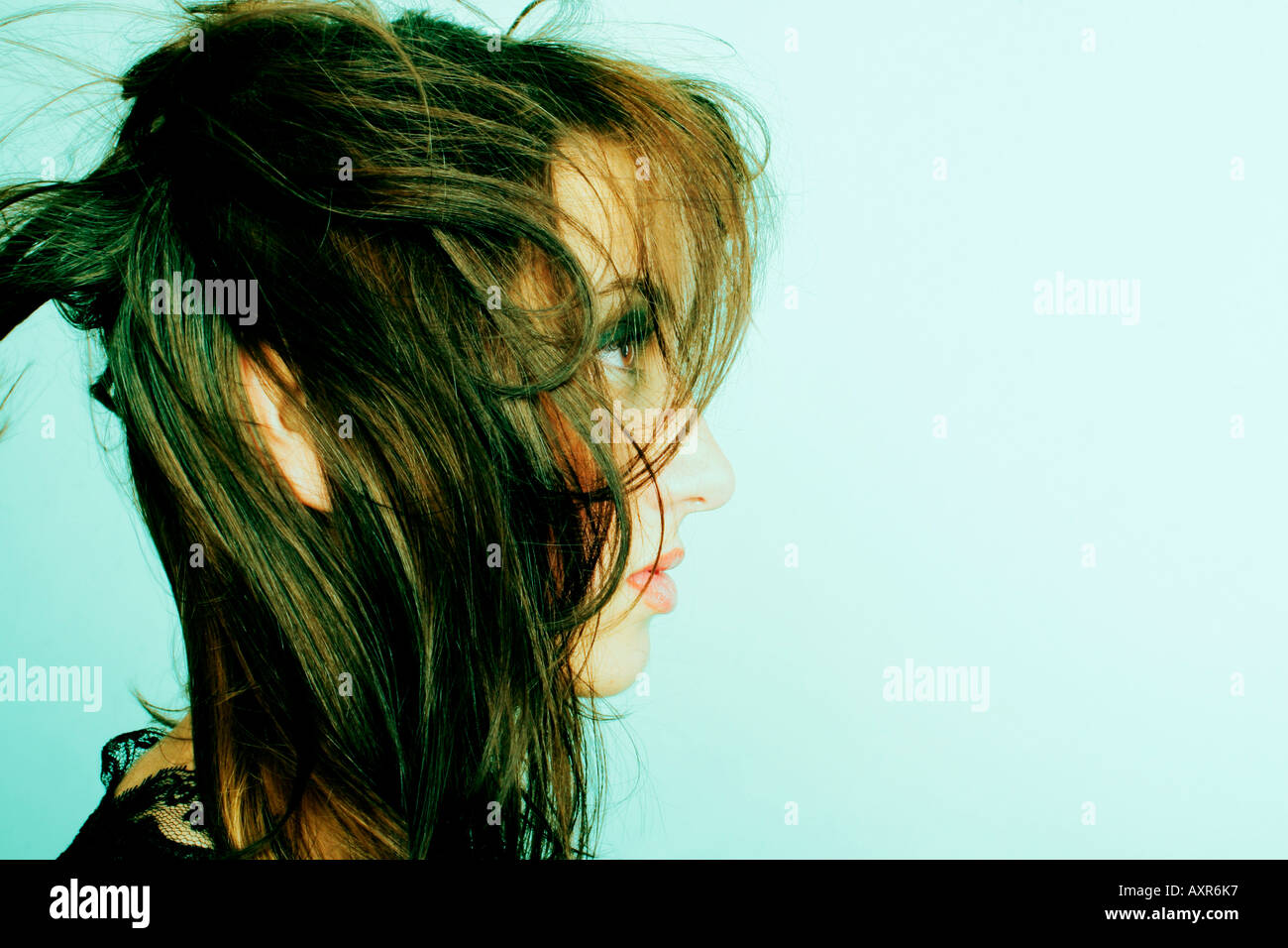 Young woman with wind blown hair Stock Photo - Alamy